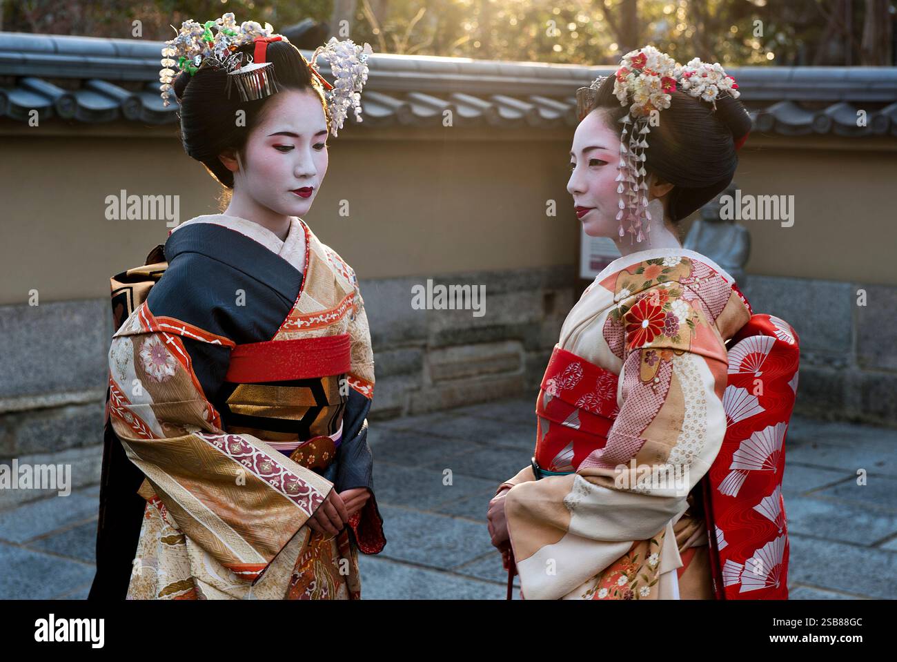Two female tourists dressed up like maiko (apprentice geisha) walking ...