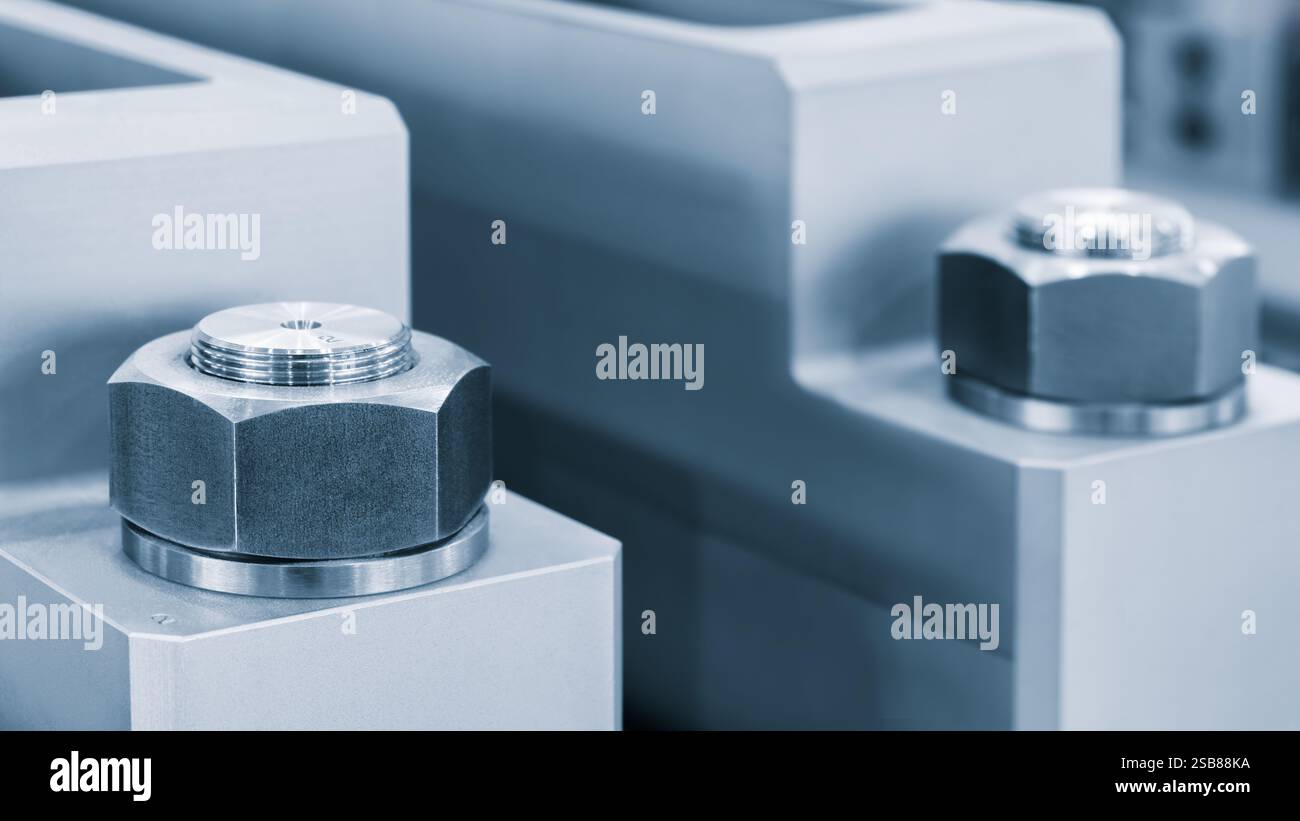 Two bolts are shown in close up, one of which is missing its head. The other bolt is missing its ...