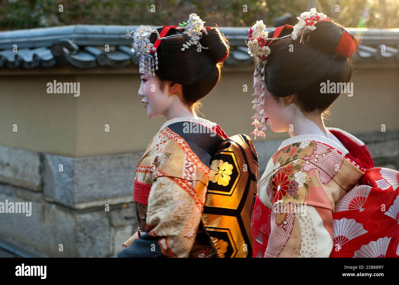 Two female tourists dressed up like maiko (apprentice geisha) walking ...