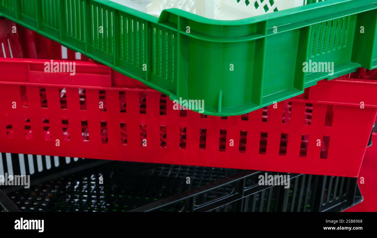 A stack of plastic containers with different colors and sizes. Concept ...