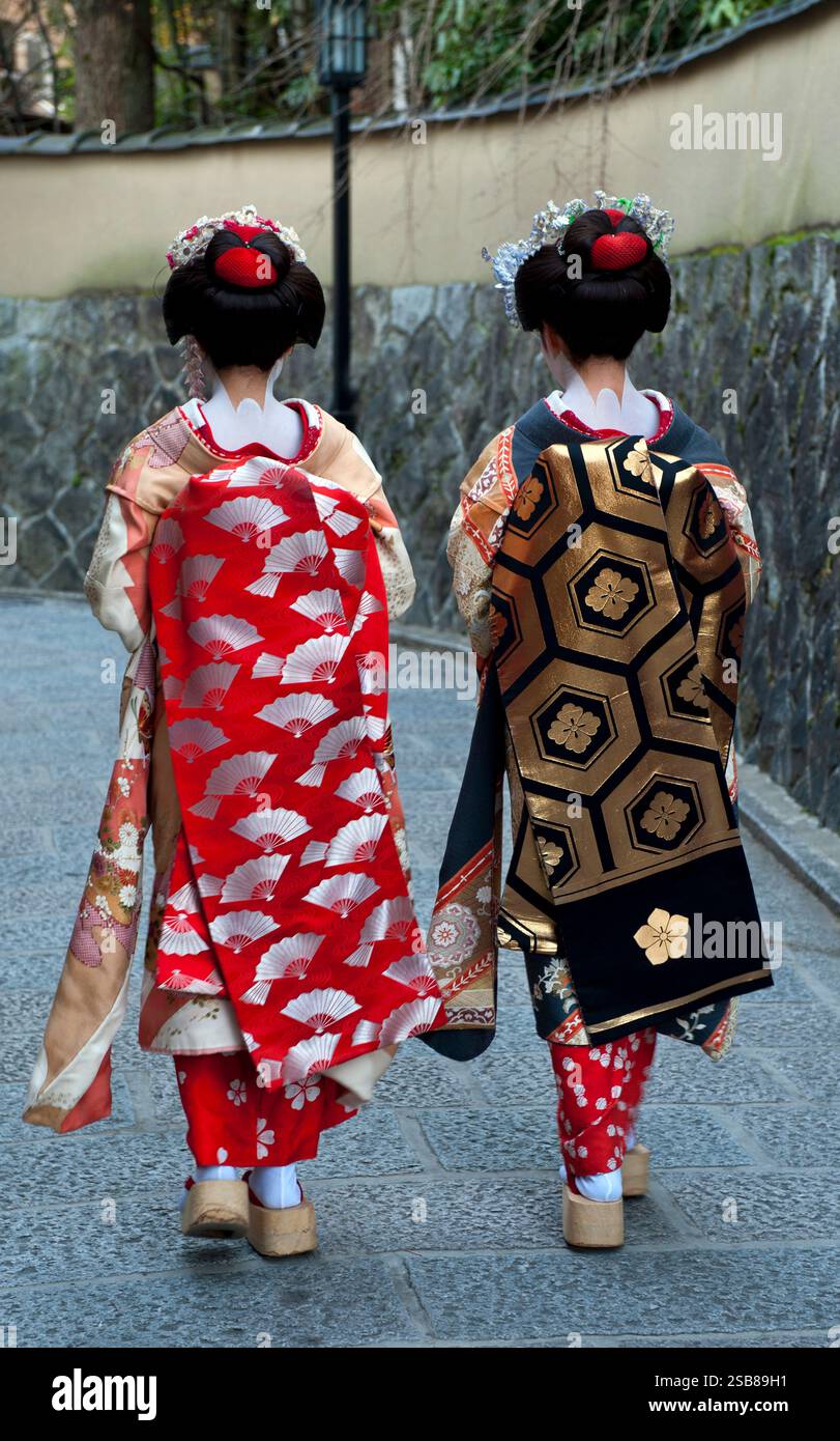 Two female tourists dressed up like maiko (apprentice geisha) walking ...