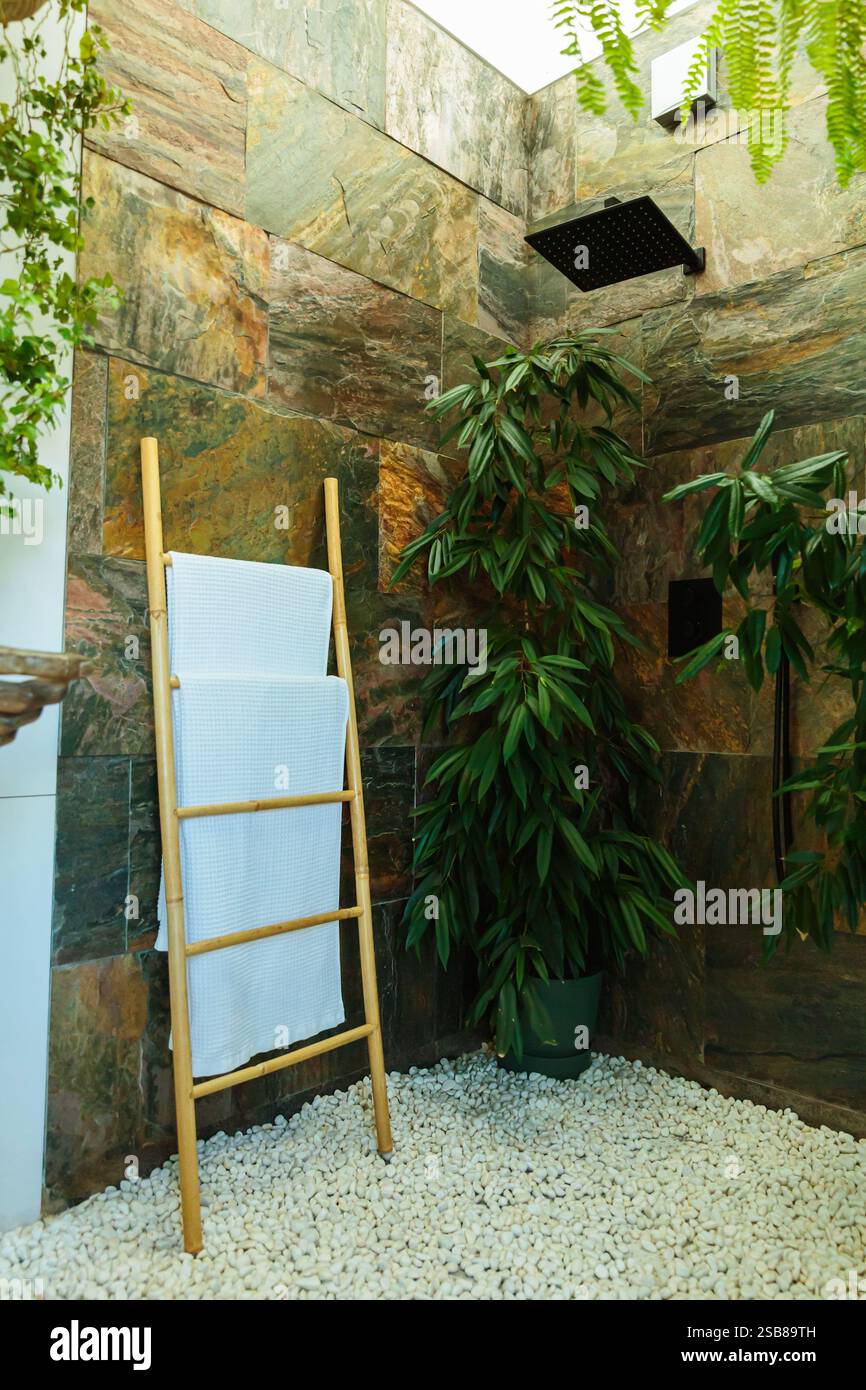 Natural shower with plants, stone walls, and bamboo decor Stock Photo ...