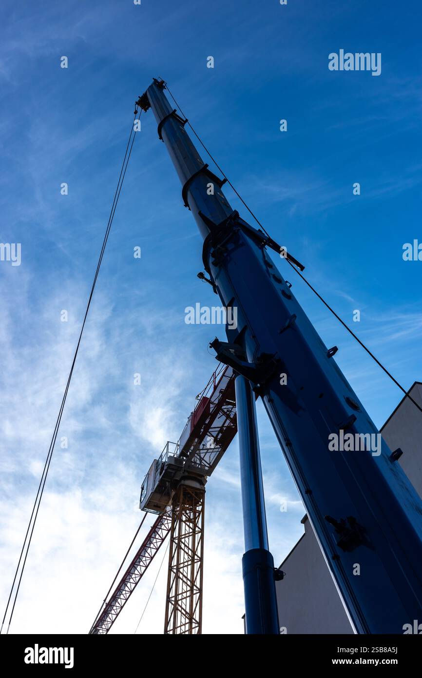 Construction of a construction crane using a mobile crane. Daytime shot ...