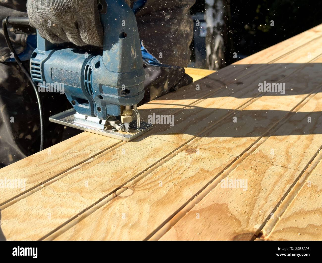 Crafting precision with a jigsaw on a bright day in a tranquil workshop ...