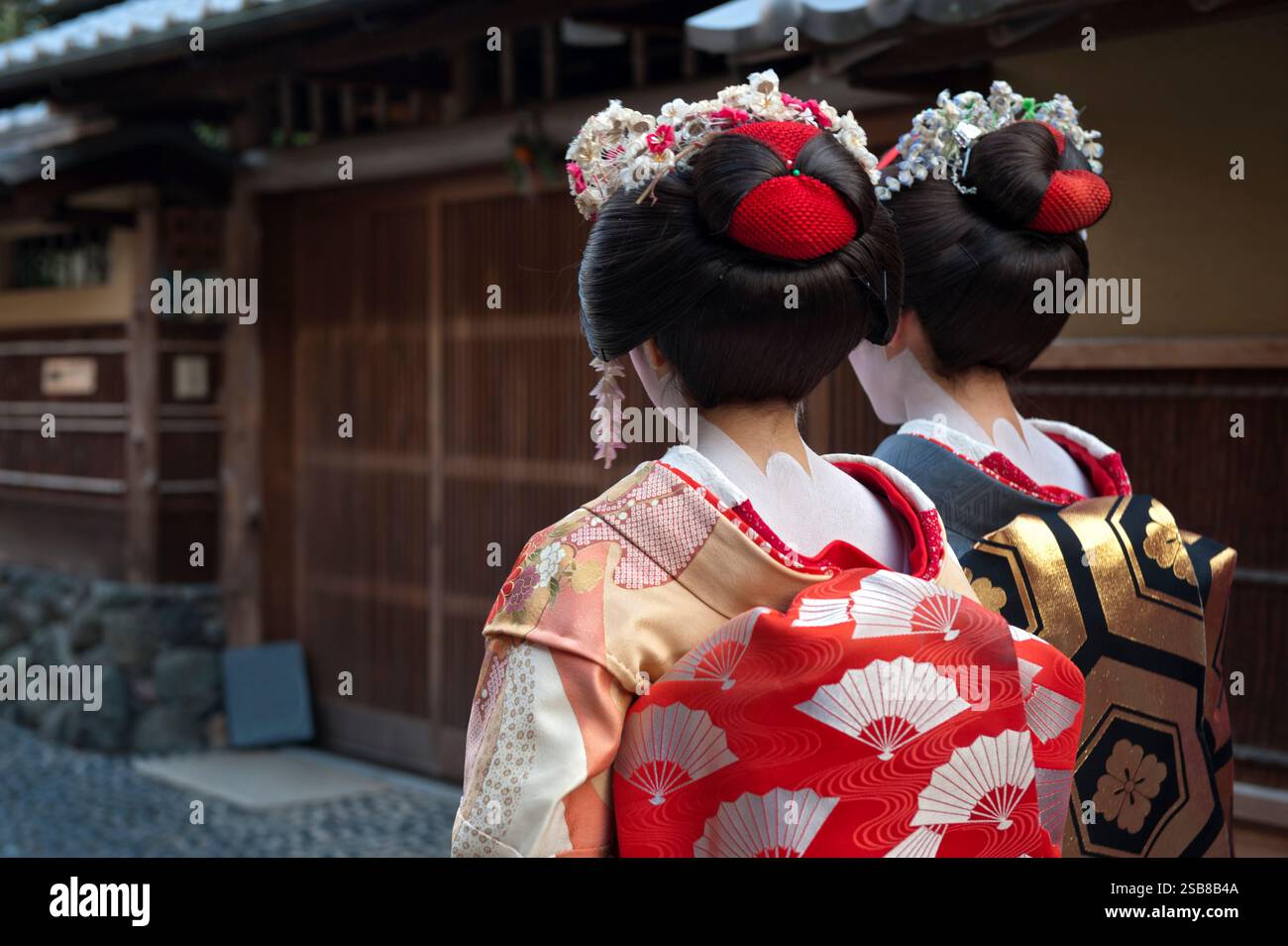 Two female tourists dressed up like maiko (apprentice geisha) walking ...