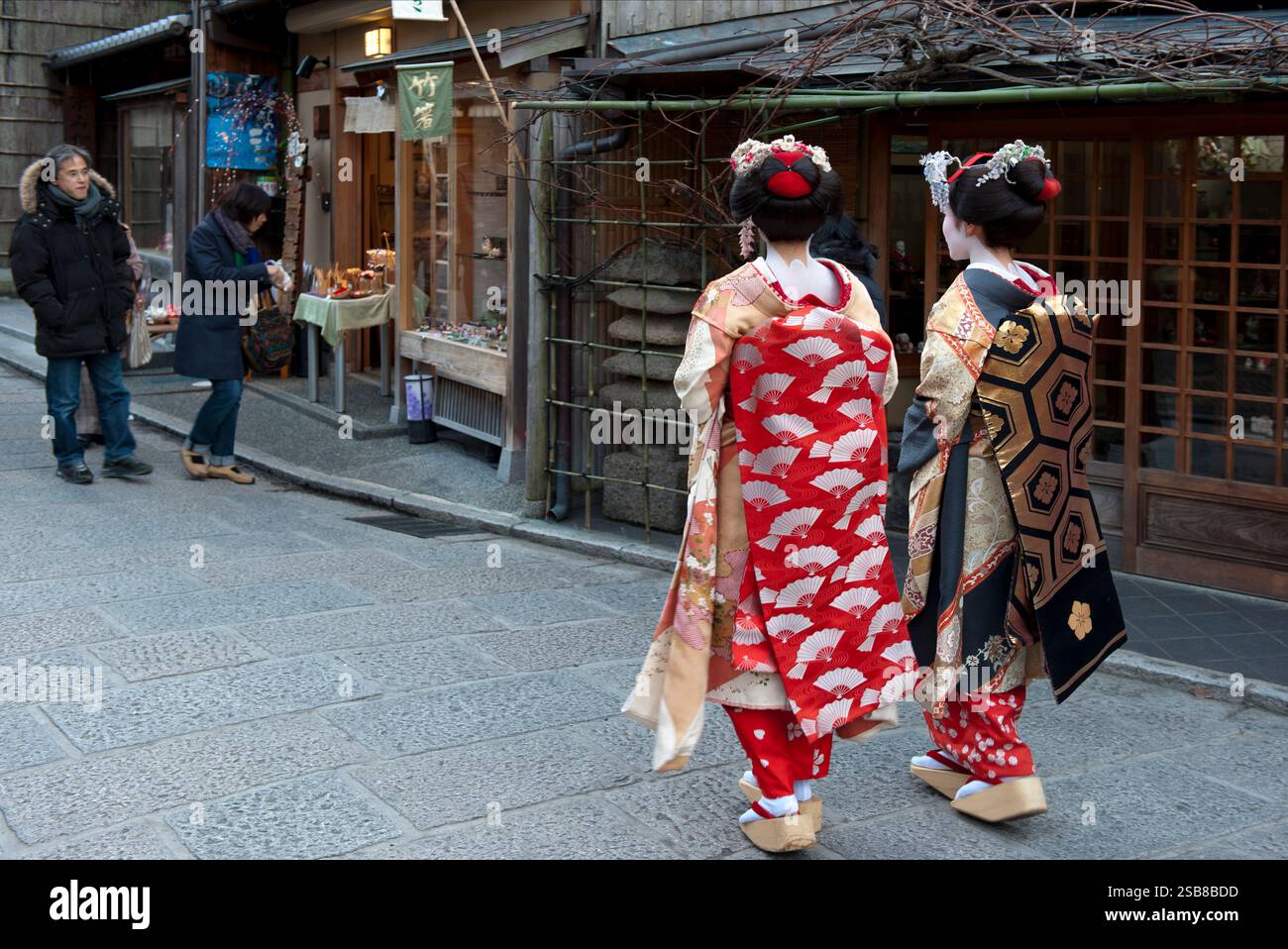 Two female tourists dressed up like maiko (apprentice geisha) walking ...