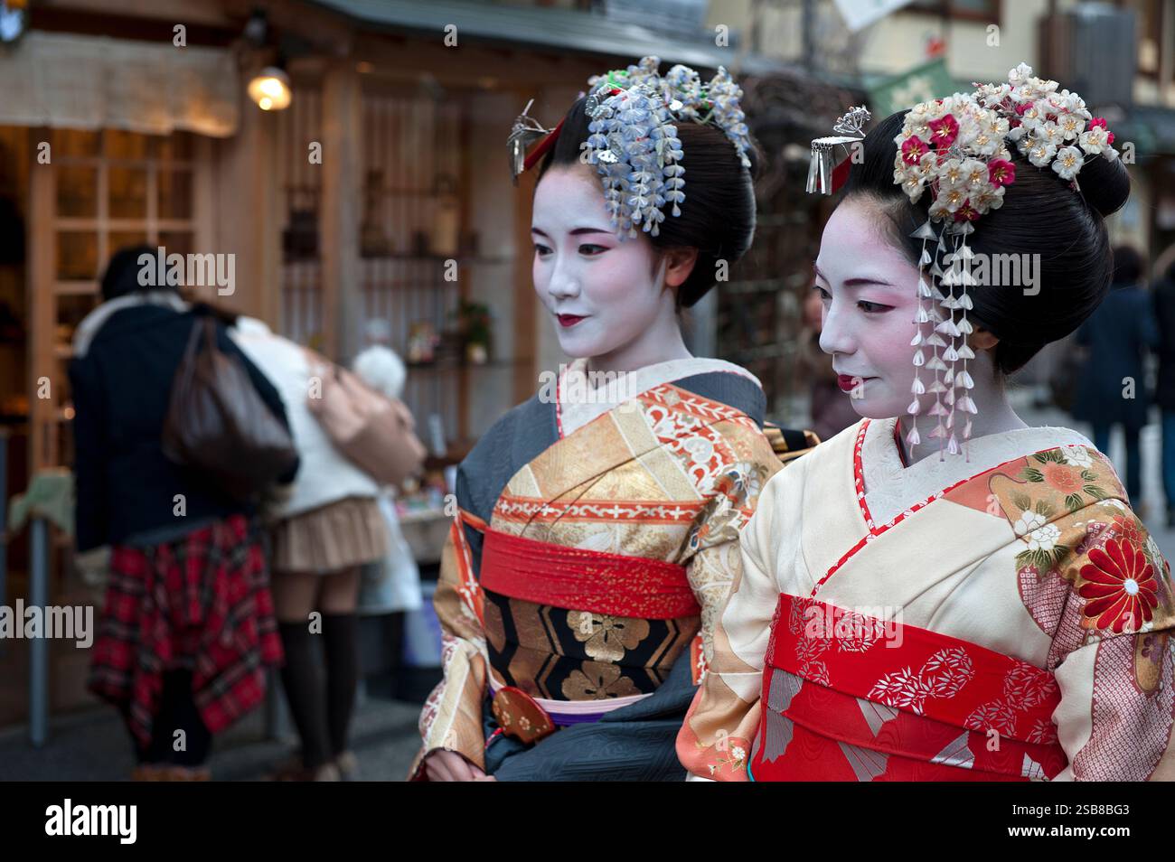 Two female tourists dressed up like maiko (apprentice geisha) walking ...