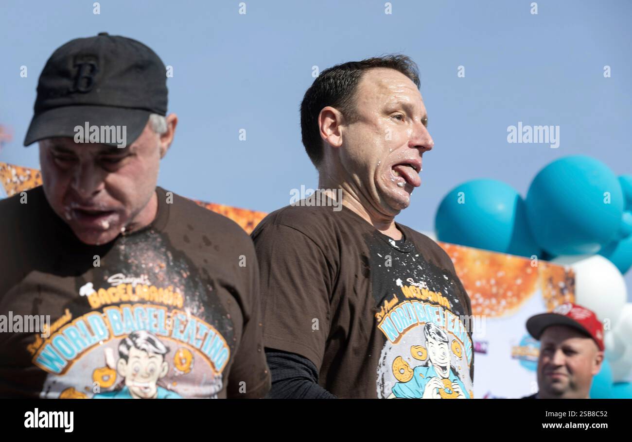 Joey Chestnut, right, reacts after competing in the during third annual ...