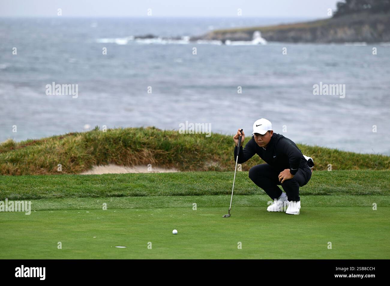 Tom Kim, of South Korea lines up his putt on the fourth green at Pebble ...