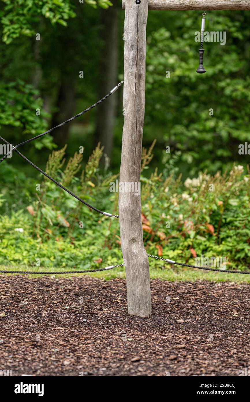outdoor playground structure with wooden beam and ropes in natural ...