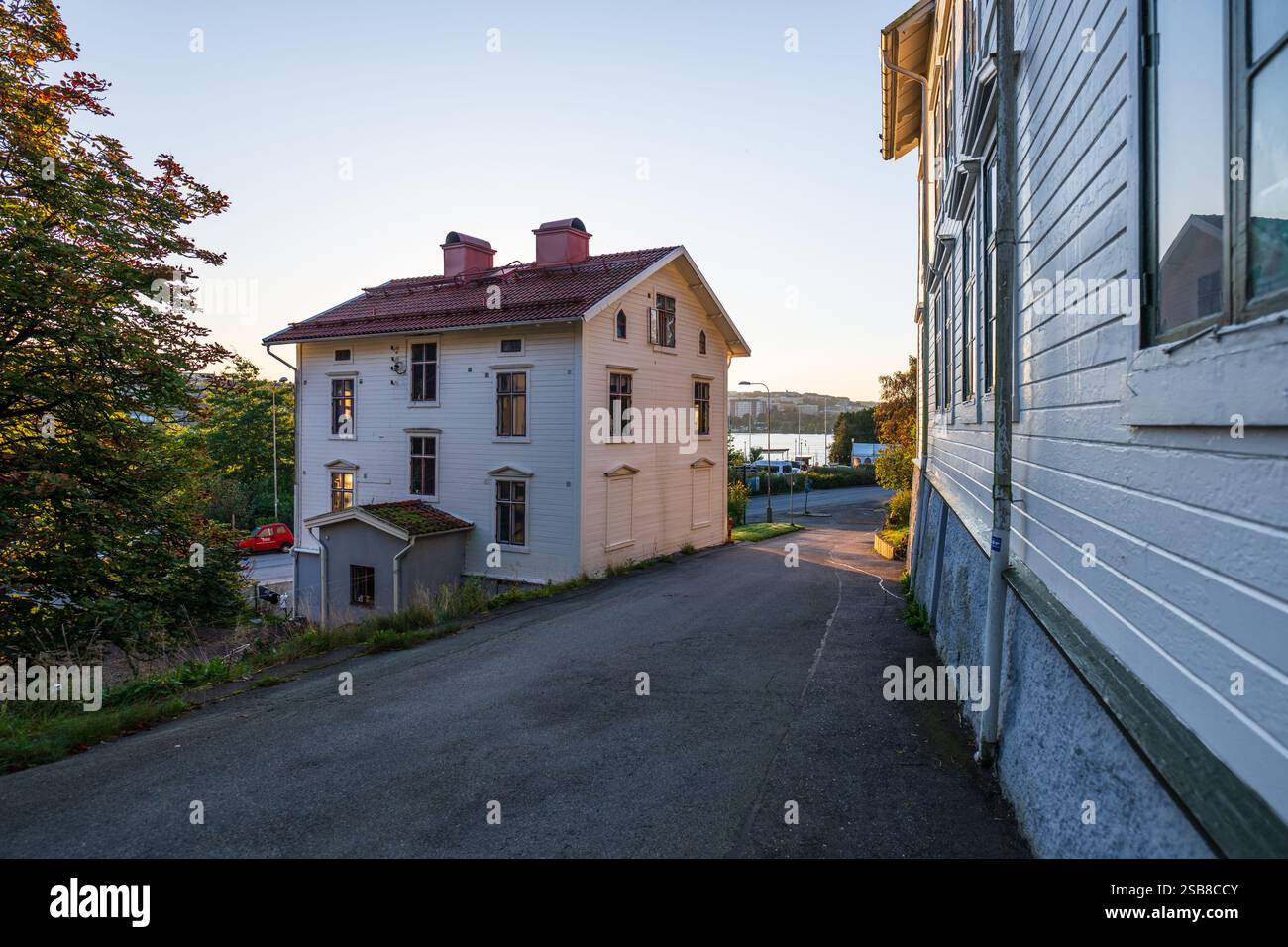 Two wooden houses built on a slope with a road between them Stock Photo ...