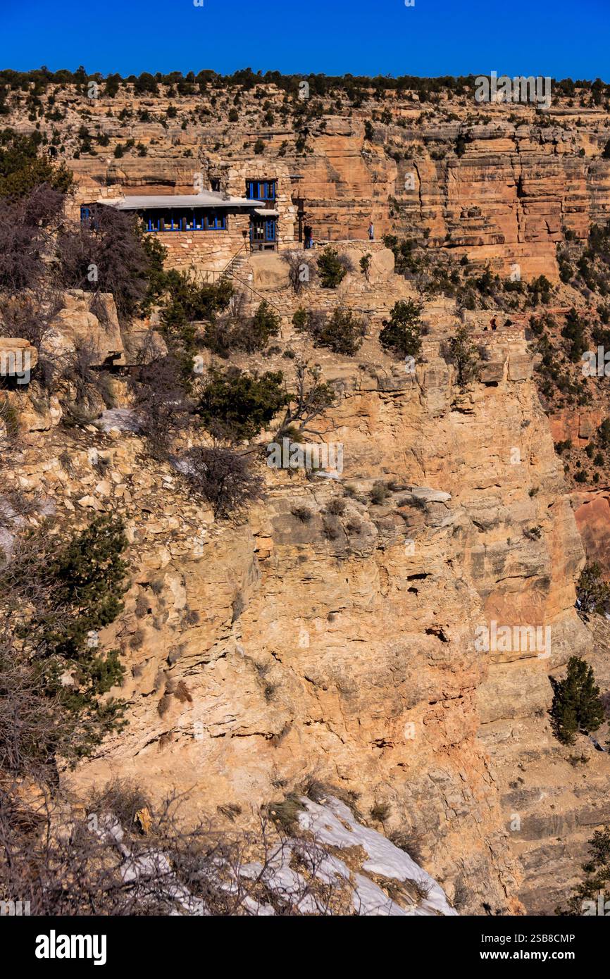 A house is built on a rocky hillside. The house is small and has a ...