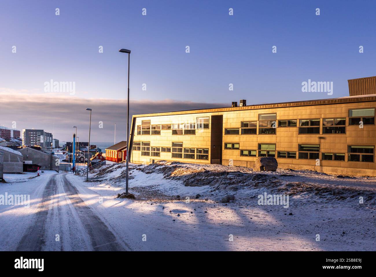 Modern office building reflecting the sun rays, on the street covered ...