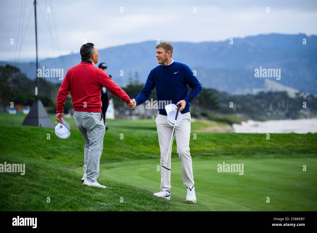 PEBBLE BEACH, CA - JANUARY 30: Cam Davis shakes hands with Ping Duan ...