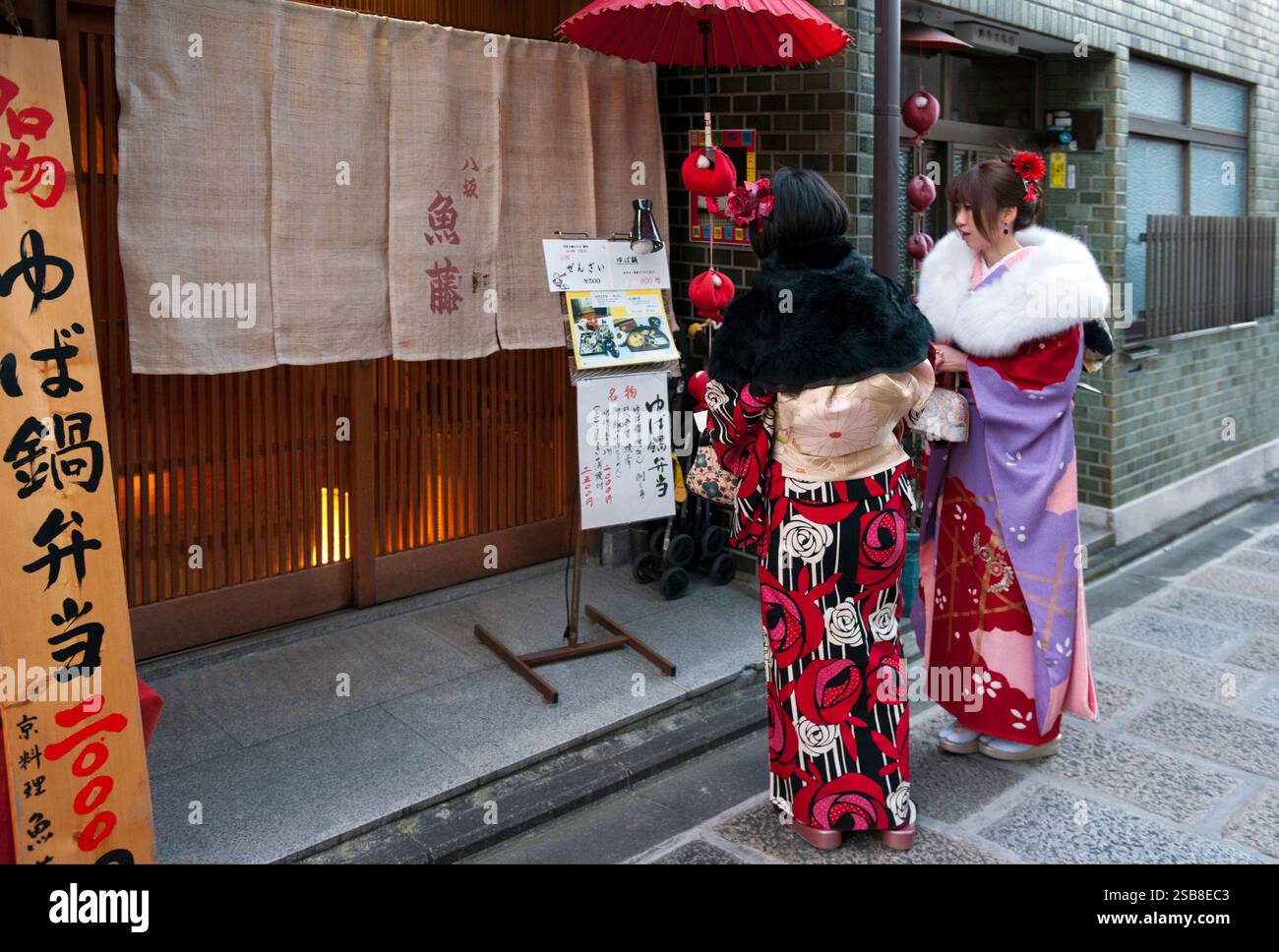 Female tourists dressed in colorful kimono yukata robes seen strolling ...