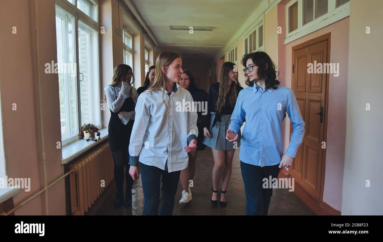 High school students enjoying their break time, walking and chatting in the school hallway Stock ...