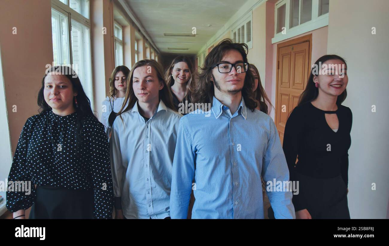 Happy high school students enjoying a break as they walk together in a ...