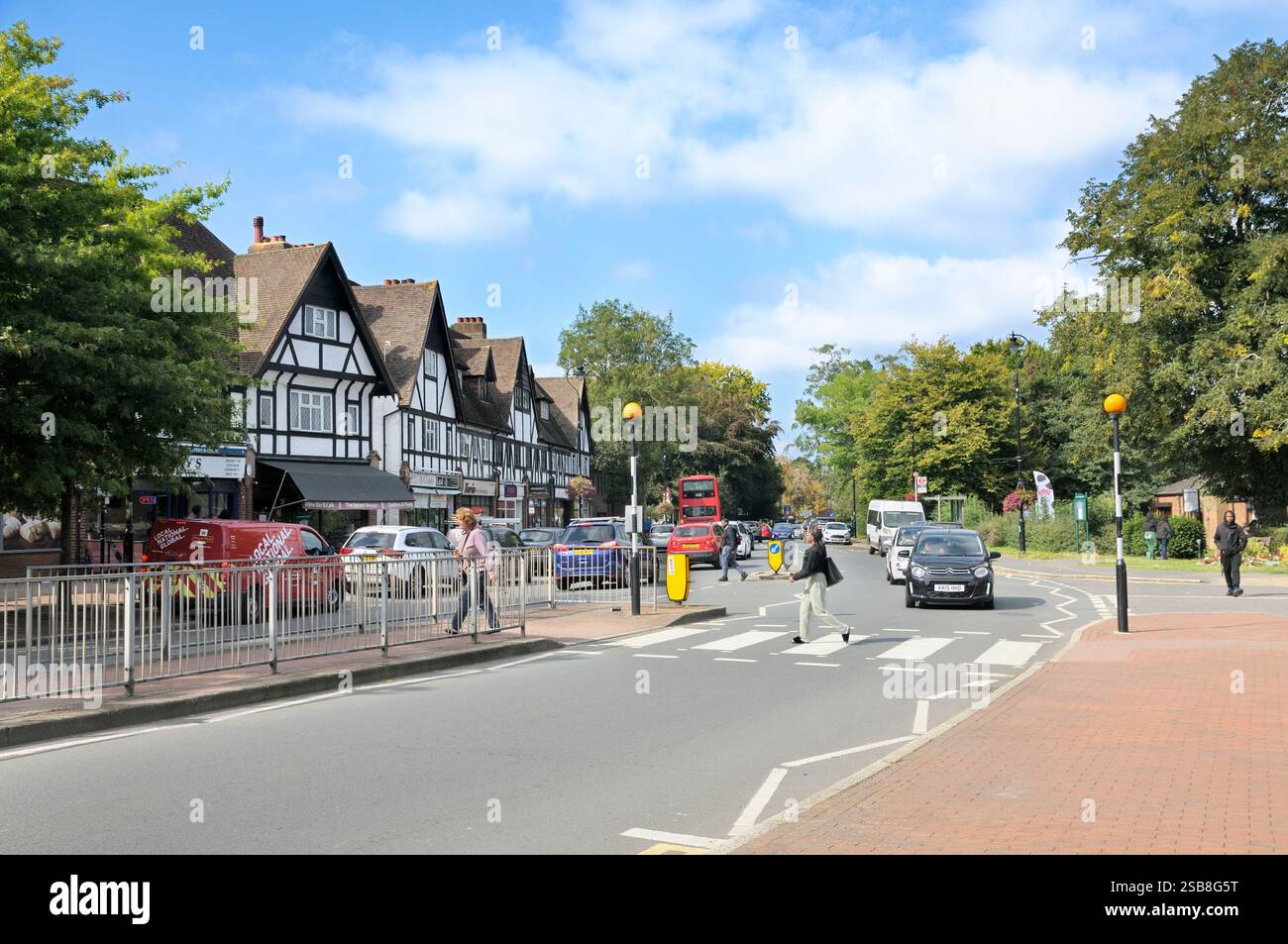 Pedestrians using a typical zebra crossing with Belisha beacons on ...