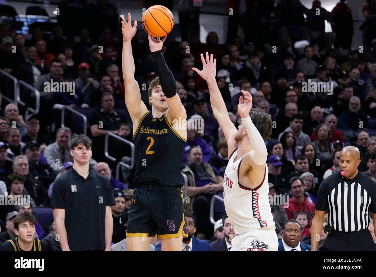 Northwestern forward Nick Martinelli (2) looks to shoot over Wisconsin forward Carter Gilmore ...
