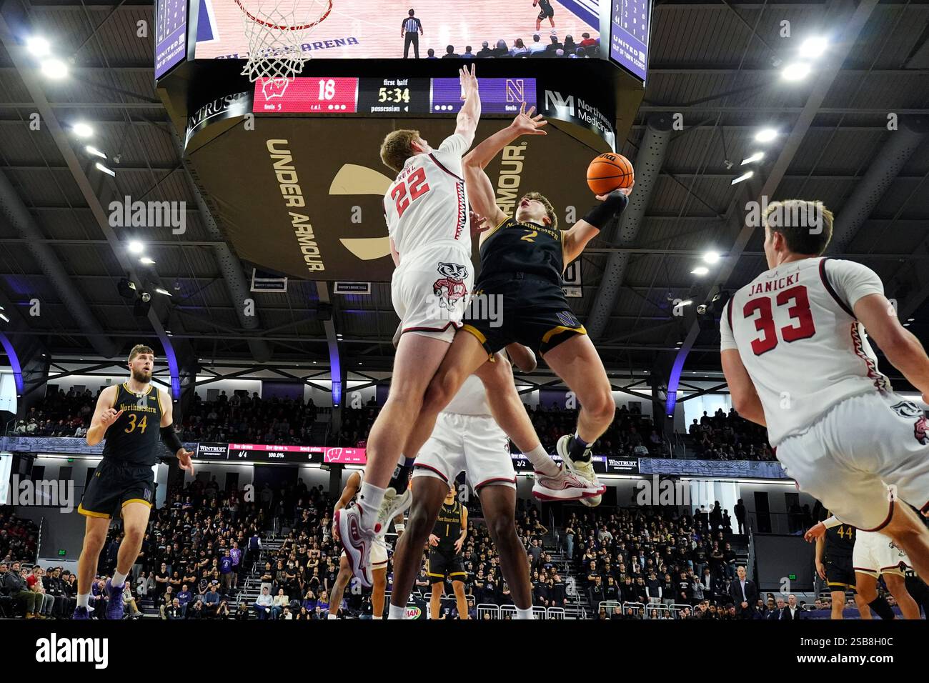 Northwestern forward Nick Martinelli (2) shoots against Wisconsin forward Steven Crowl (22 ...
