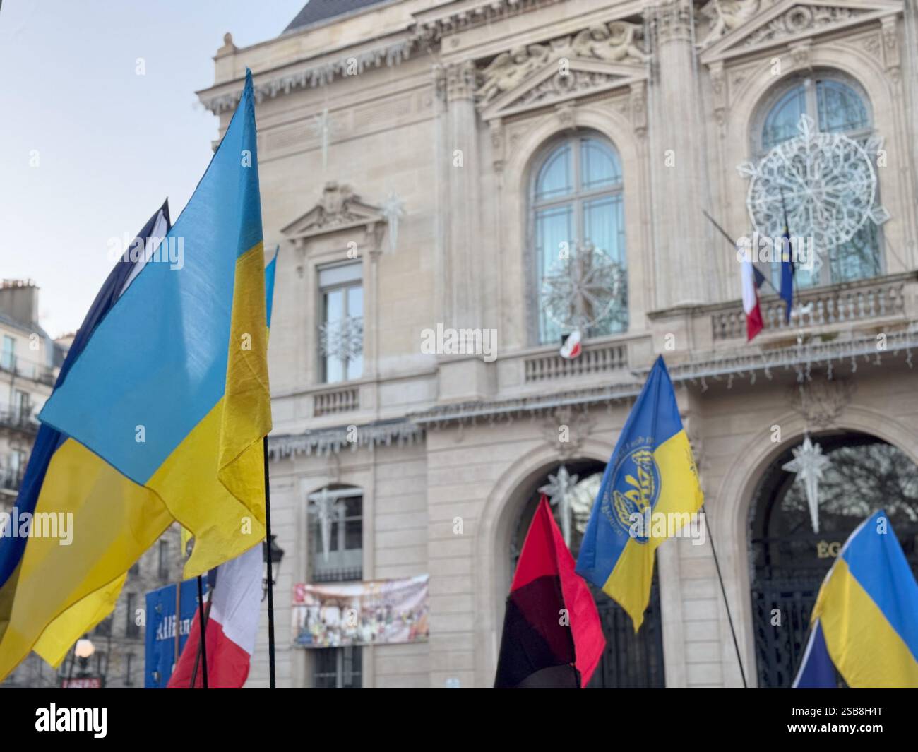 Colorful flags wave in unity at a peaceful gathering outside a historic ...