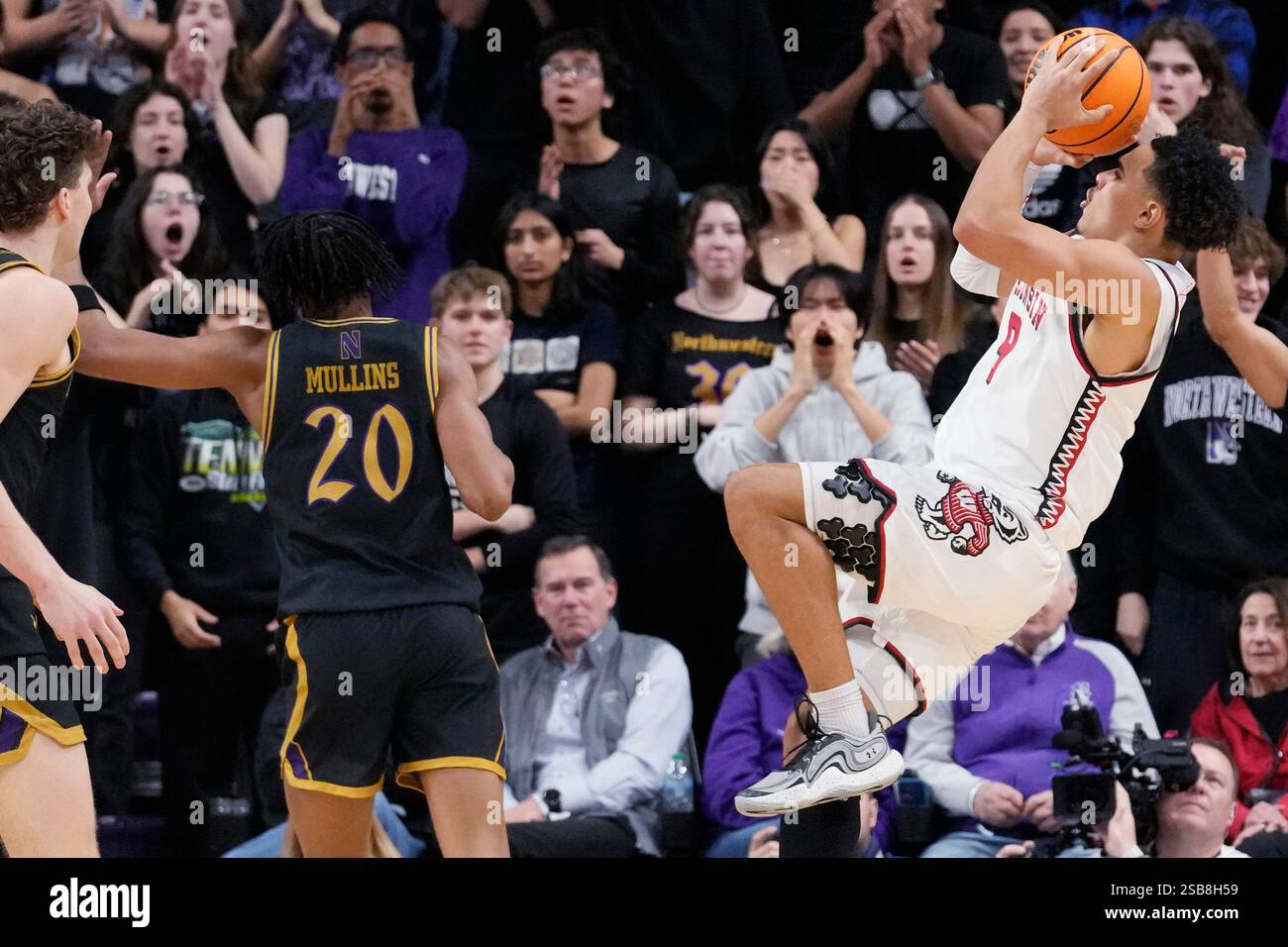 Wisconsin guard John Tonje, right, shoots against Northwestern guard ...