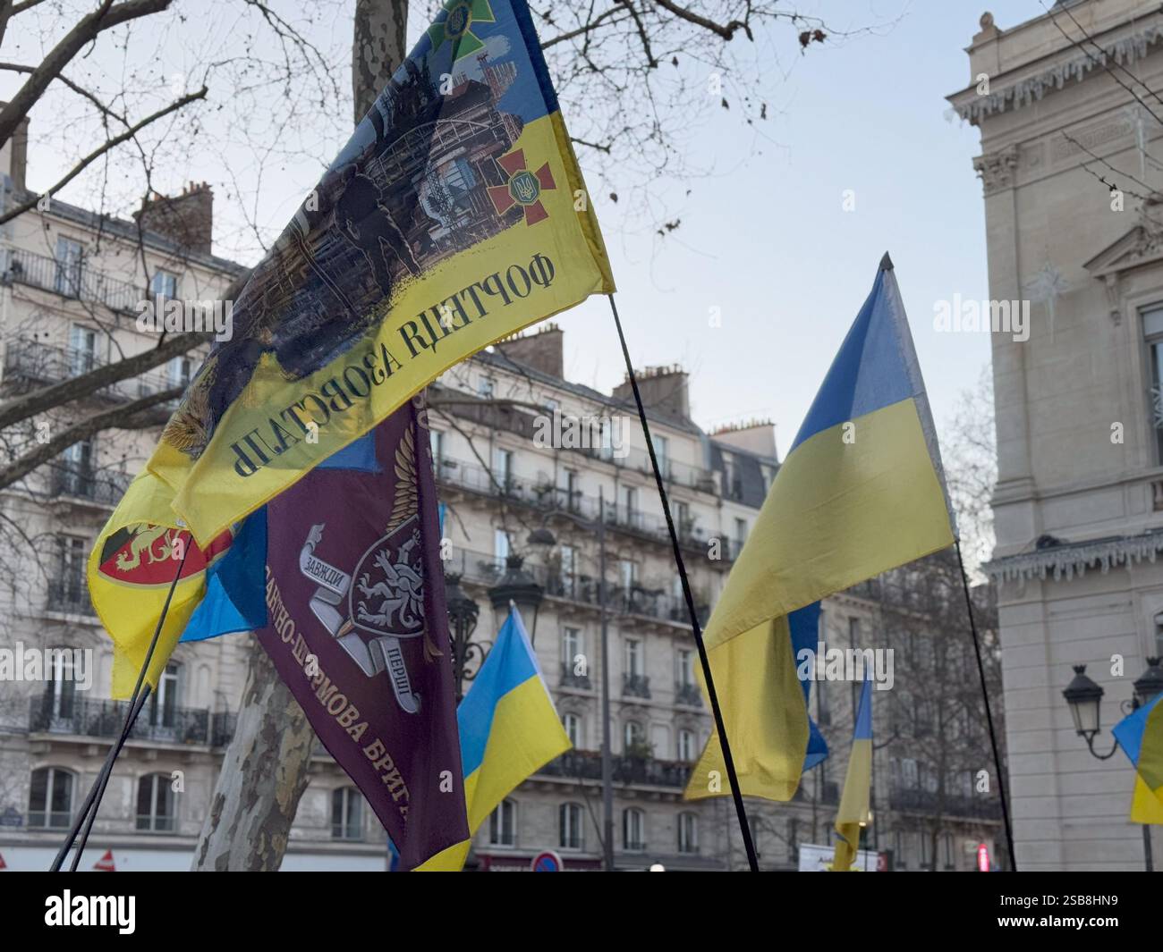 Colorful flags wave near historic buildings at a lively city event ...
