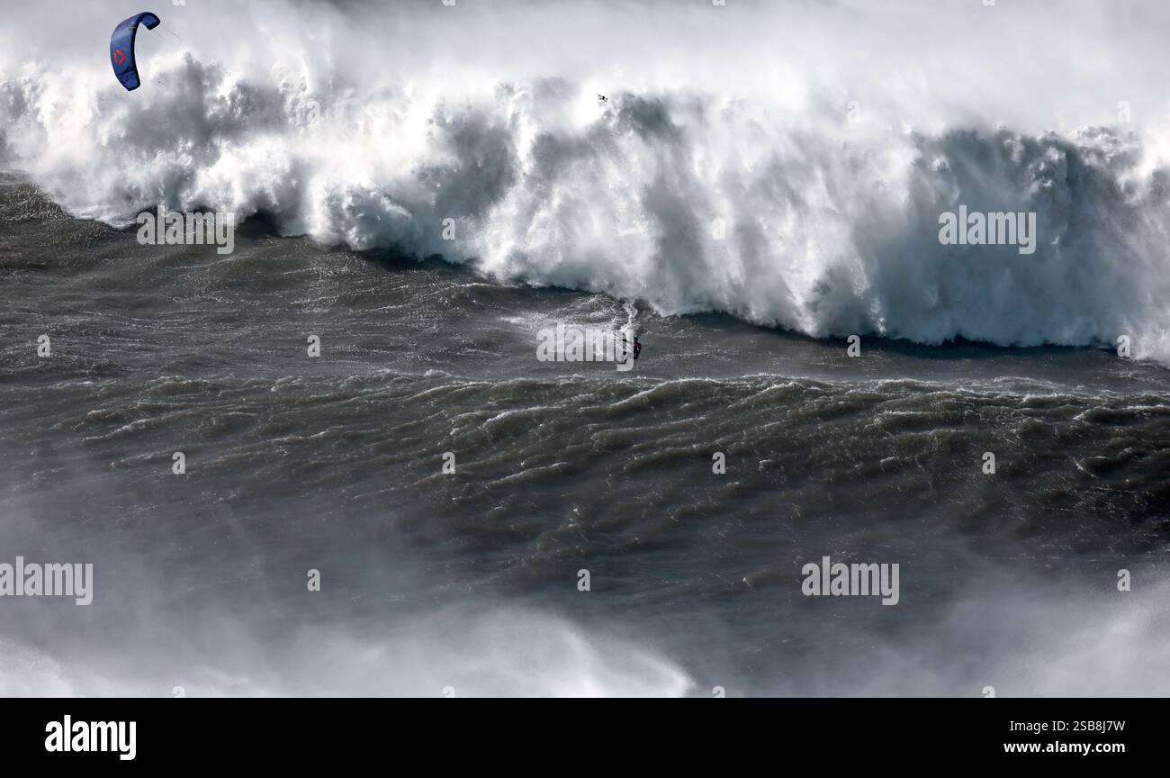 NAZARE, PORTUGAL - JANUARY 30: James Carew of Australia is kitesurfing ...