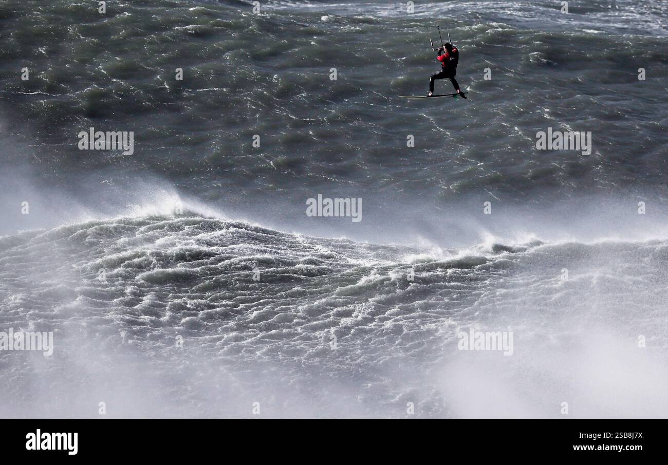 NAZARE, PORTUGAL - JANUARY 30: James Carew of Australia is kitesurfing ...