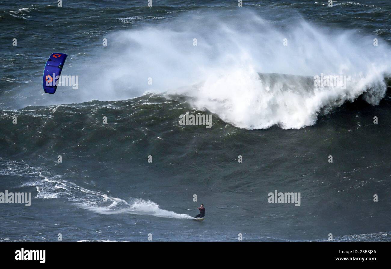NAZARE, PORTUGAL - JANUARY 30: James Carew of Australia is kitesurfing ...