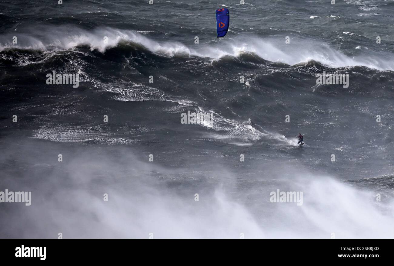 NAZARE, PORTUGAL - JANUARY 30: James Carew of Australia is kitesurfing ...
