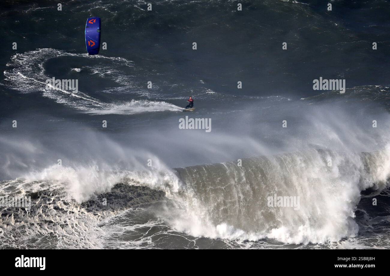 NAZARE, PORTUGAL - JANUARY 30: James Carew of Australia is kitesurfing ...