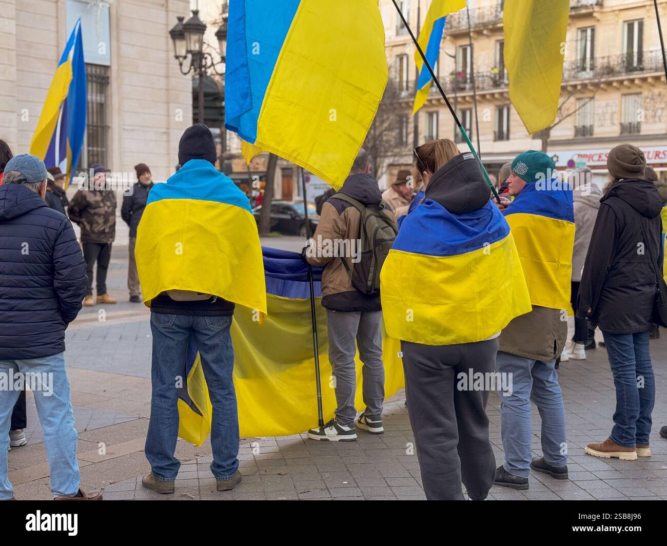 Supporters unite under blue and yellow flags in a vibrant gathering ...