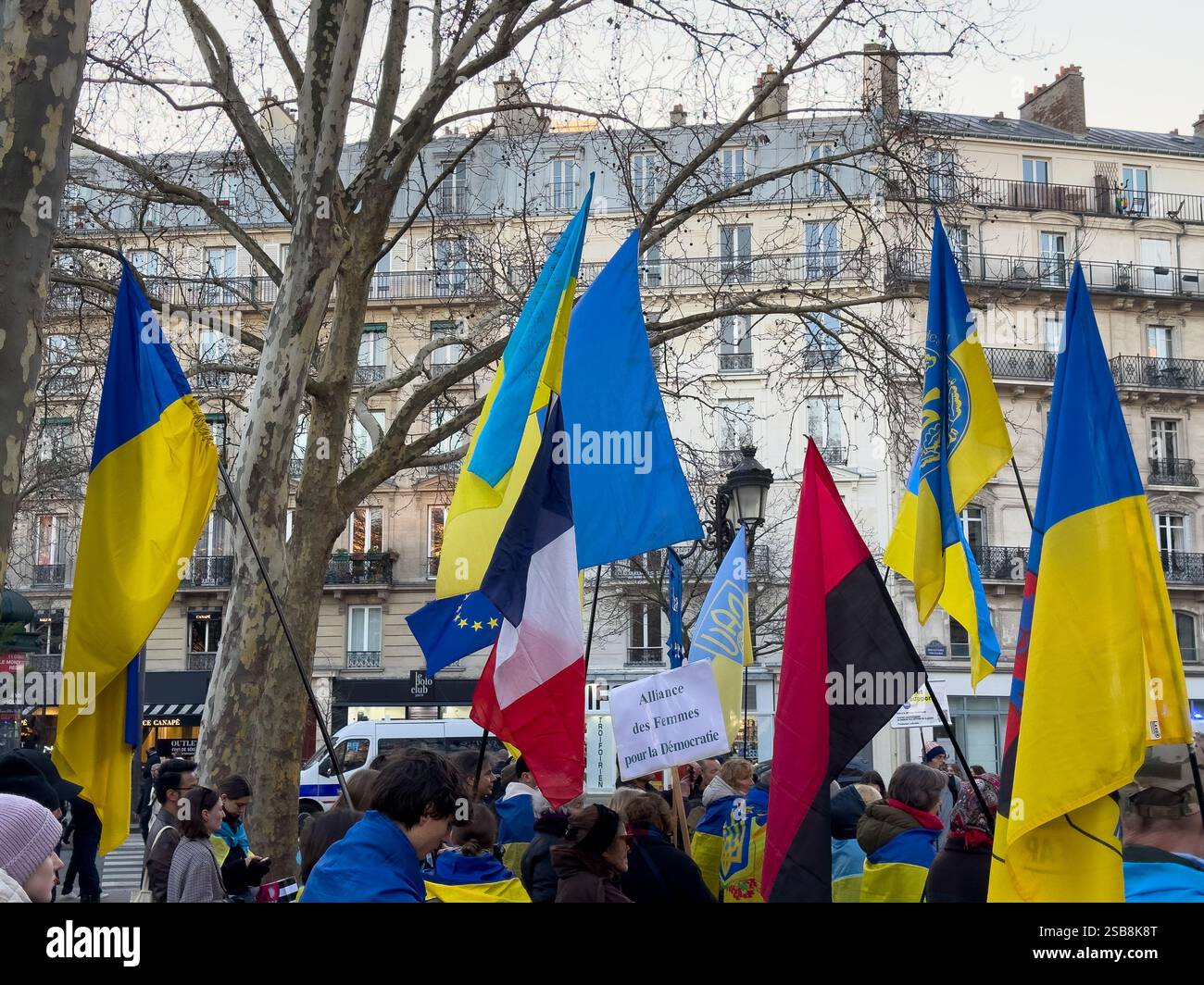Vibrant demonstration of unity with colorful flags in a Parisian square ...