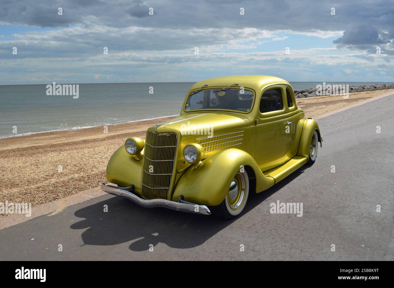 Classic Gold Ford vintage car in rally on Felixstowe seafront Stock ...