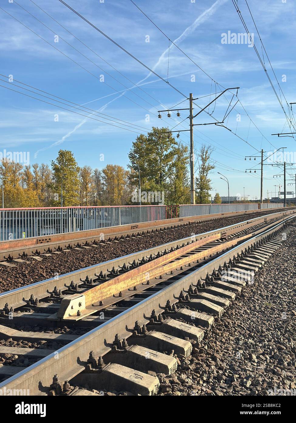 Railway tracks with overhead power lines on sunny day. Old train tracks ...