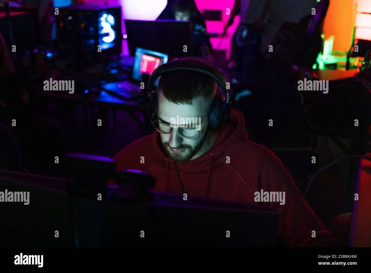 Man gamer participant in a gaming competition, sitting in front of a ...