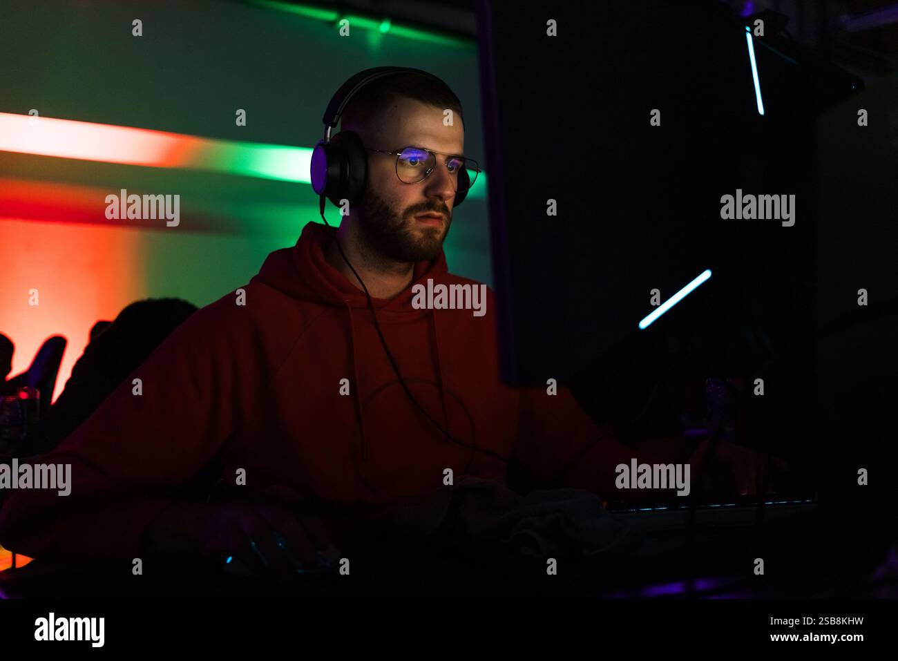 Man gamer participant in a gaming competition, sitting in front of a ...