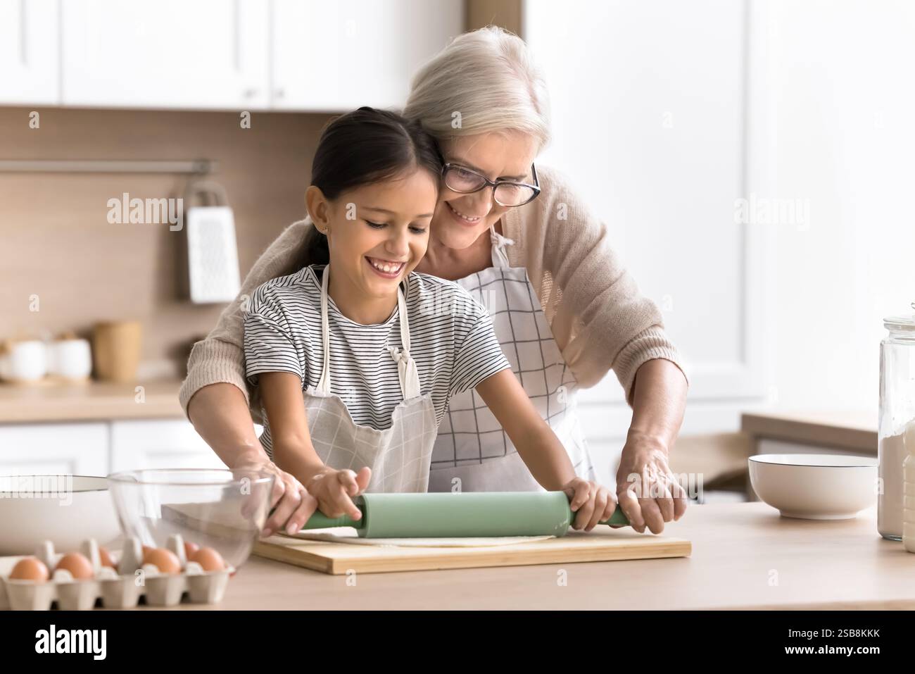 Caring aged grandmother teach little child grandkid to roll dough Stock Photo - Alamy