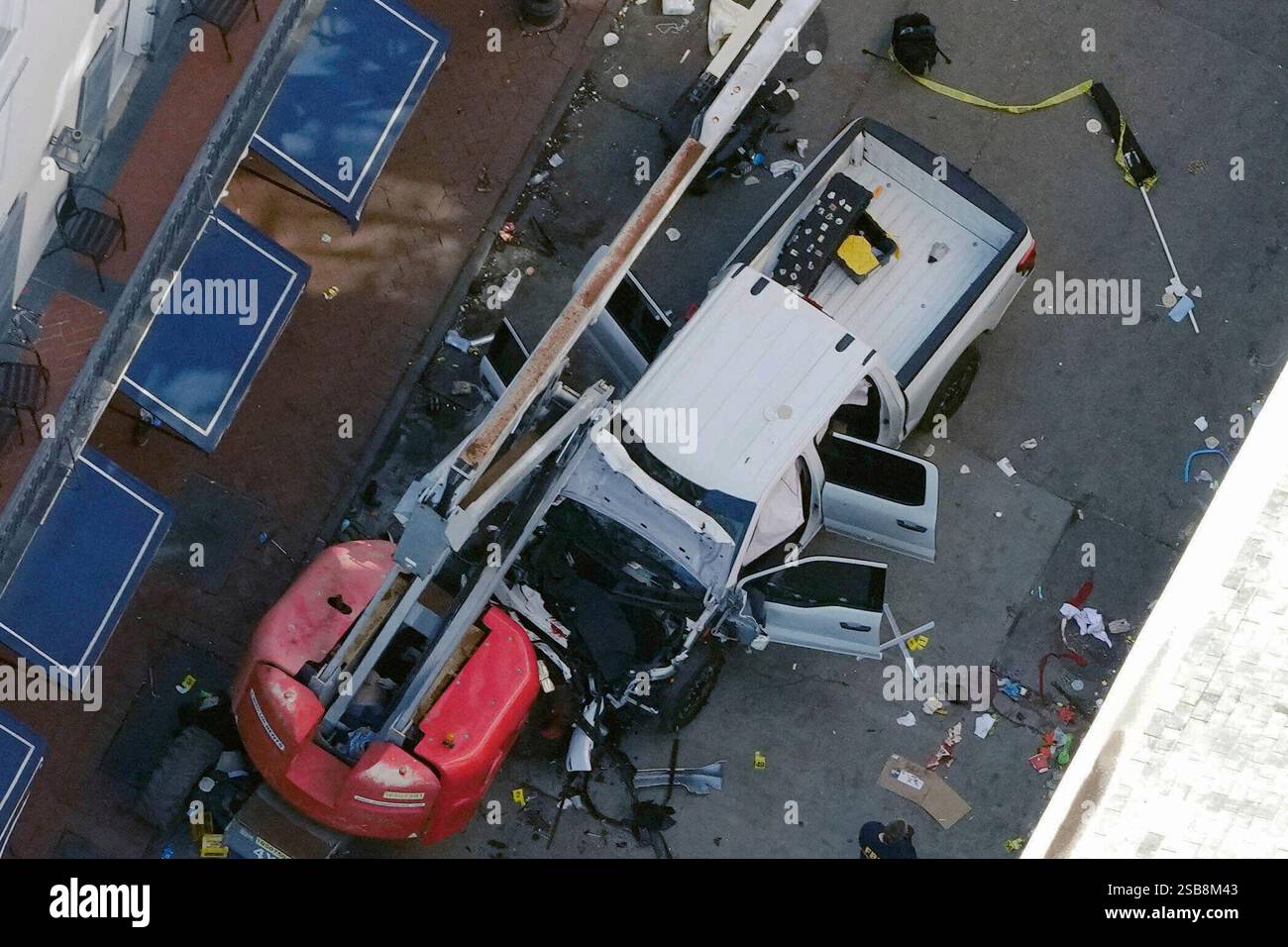 FILE - An Islamic State flag lies on the ground rolled up behind the ...