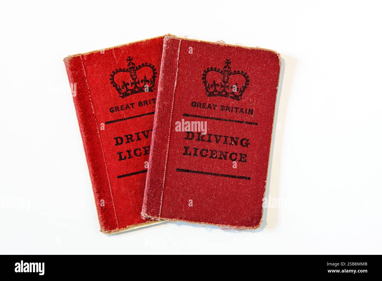 2 old red, fabric covered UK driving licences, dated 1969 and 1975 on ...