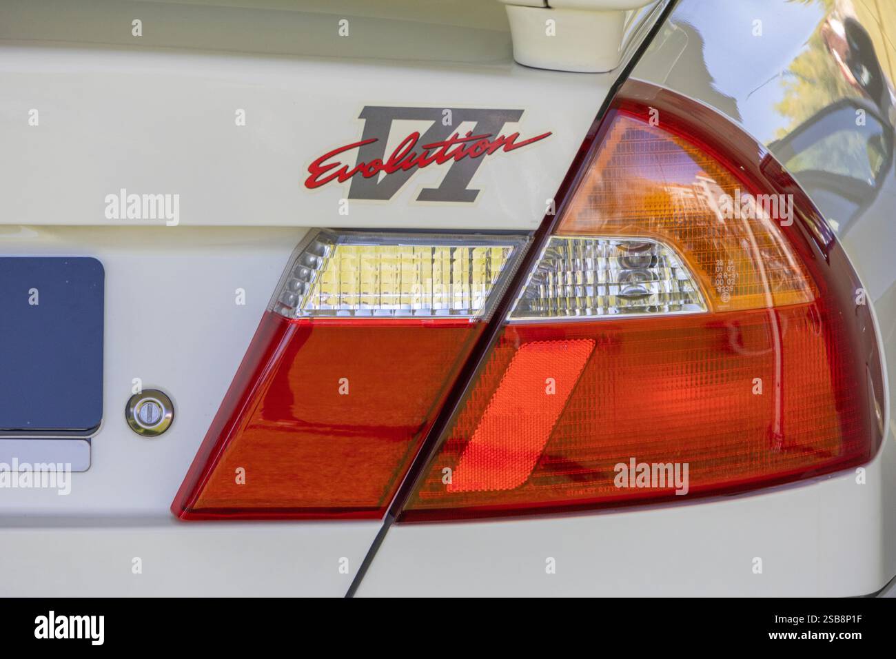Detailed view of the rear light cluster of a white mitsubishi evolution ...