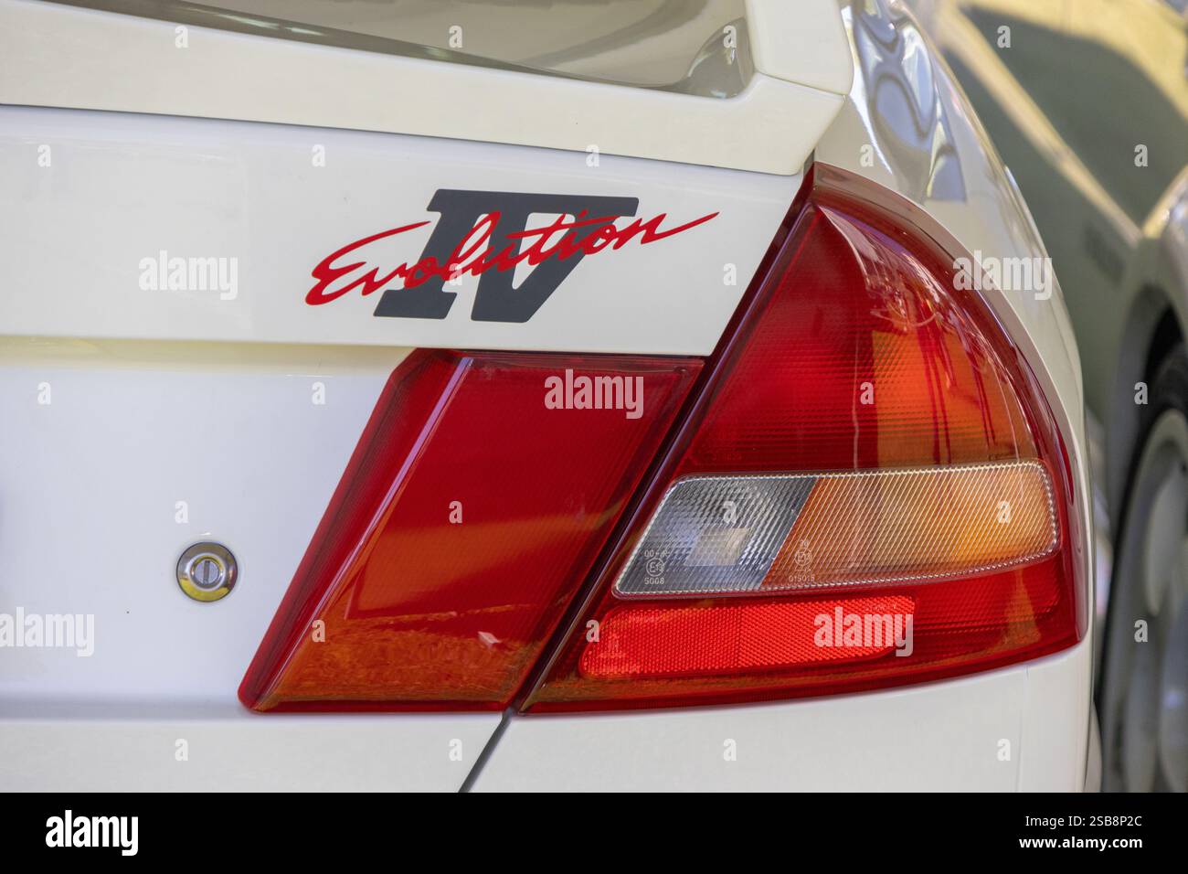 Red taillight of white mitsubishi evolution iv with evolution iv emblem ...
