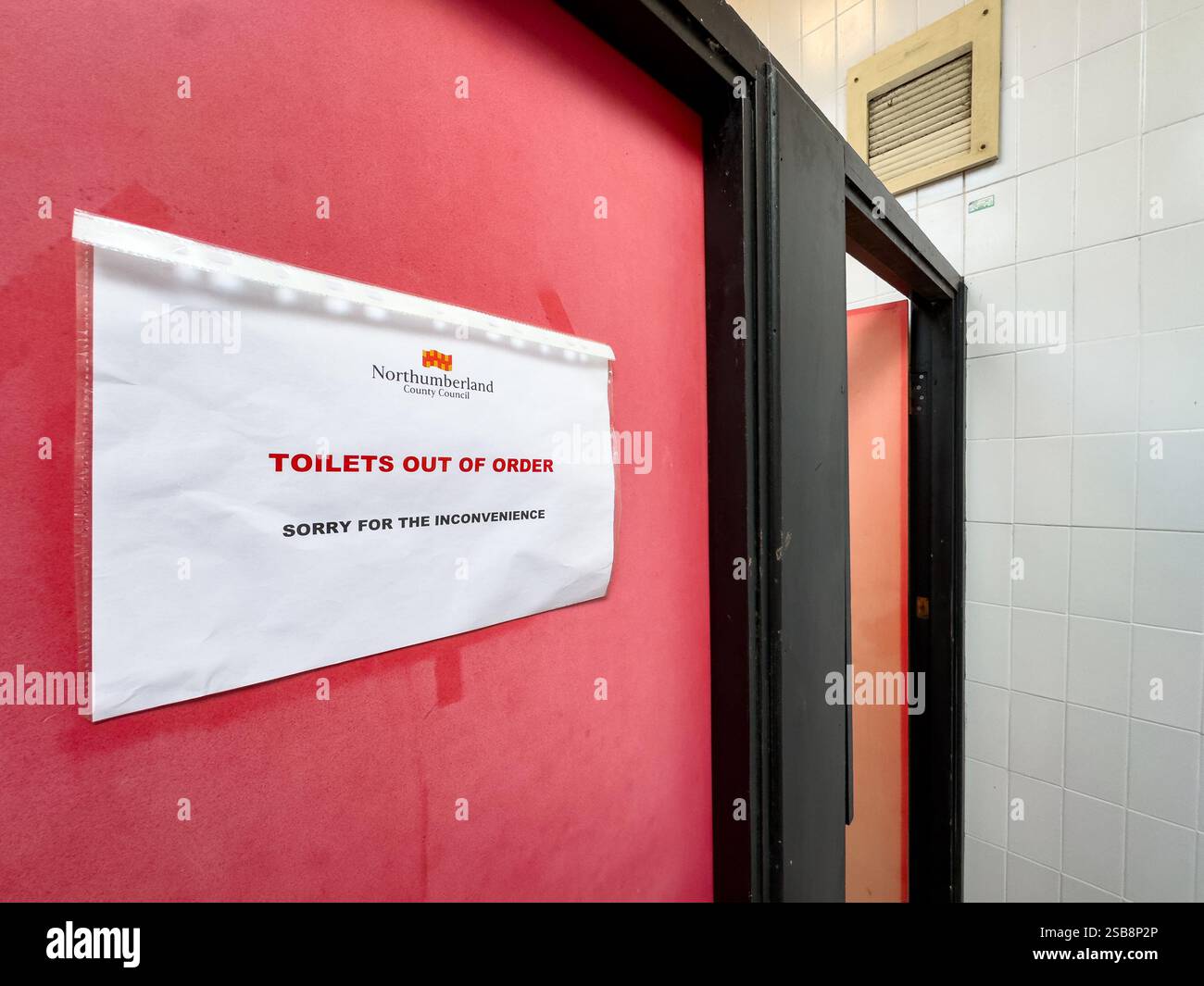 apologetic out of order printed sign on toilet cubicle or stall door in ...