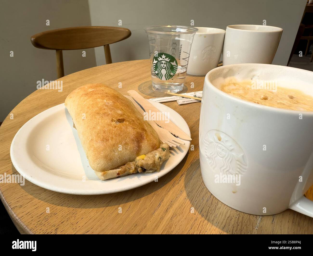 table in starbucks coffee shop with branded mug and cup and tuna melt ...