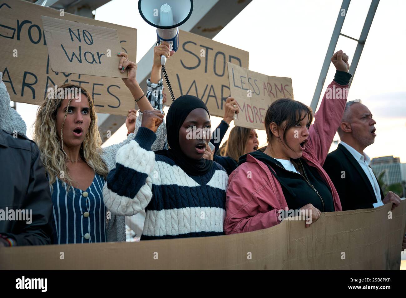 Serious multiracial group demonstrating against the war and violence in ...