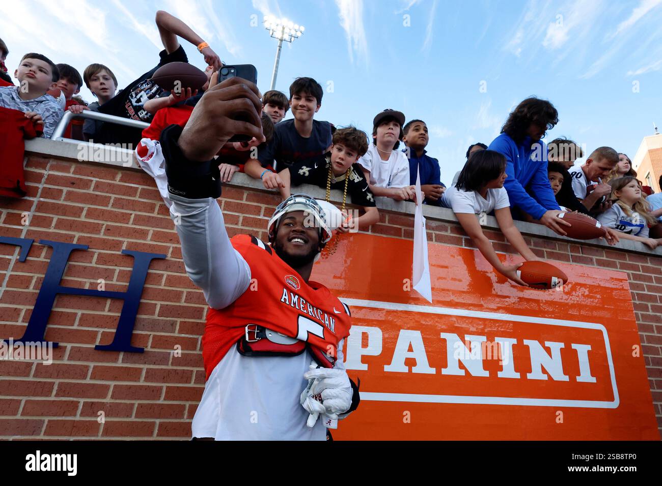 American team linebacker Tim Smith, bottom, of Alabama, takes a photo ...