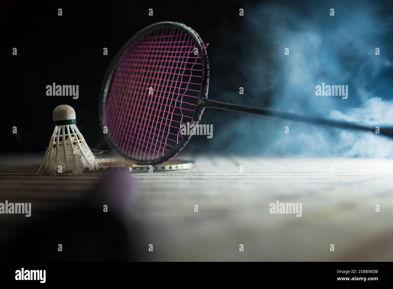 an old badminton racket with broken strings and a broken shuttlecock ...