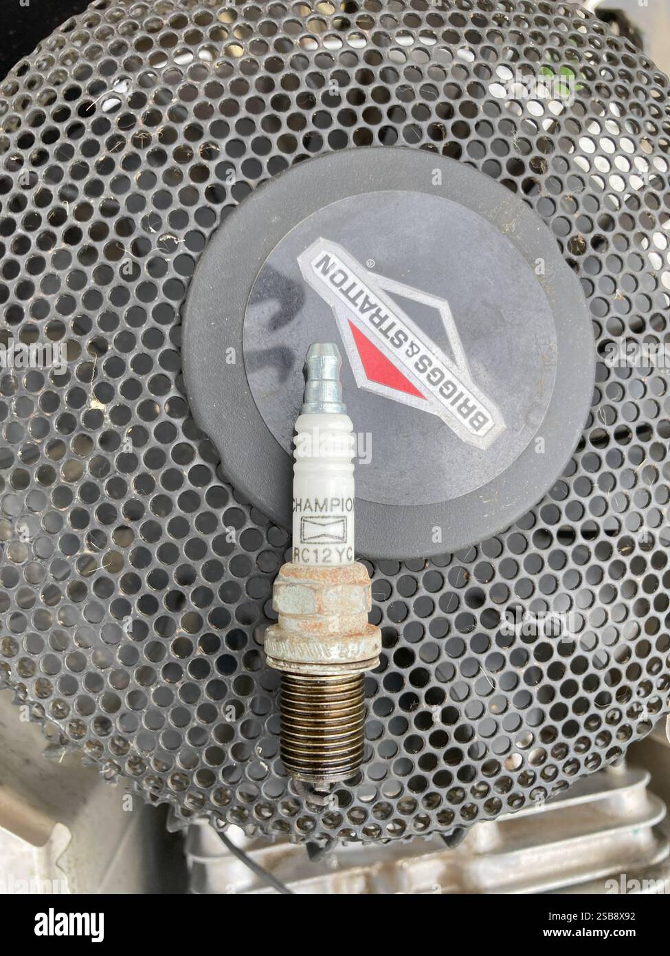 single spark plug on mower Stock Photo - Alamy