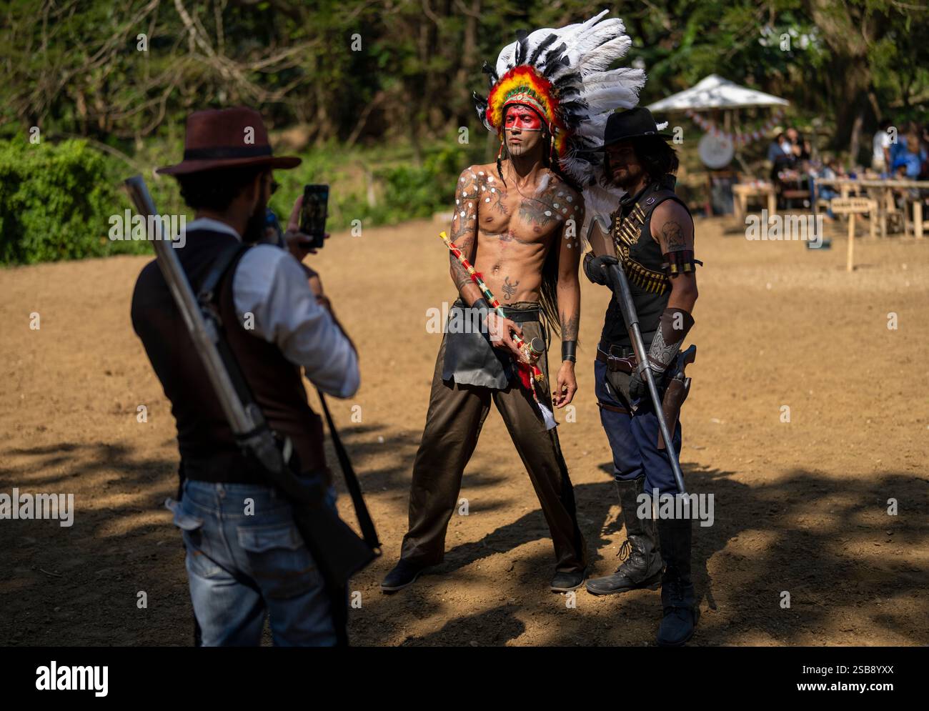 Cosplayers pose for a photo during a Wild West "theme party", organized ...